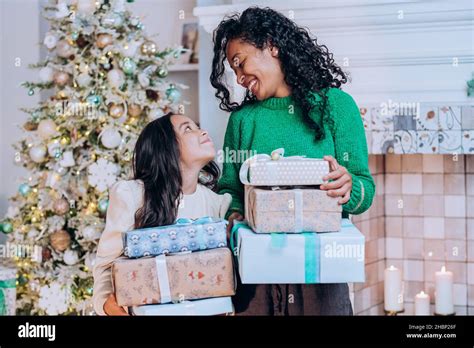 Curly Haired African American Mother And Brunette Daughter With Long