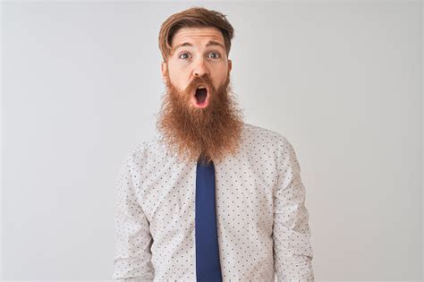 젊은 빨간 머리 아일랜드어 사업가 서 고립 된 흰색 배경 에 충격 얼굴 보고 회의적이 고 비꼬는 열린 입에 놀랐다 경영자에 대한 스톡 사진 및 기타 이미지 Istock