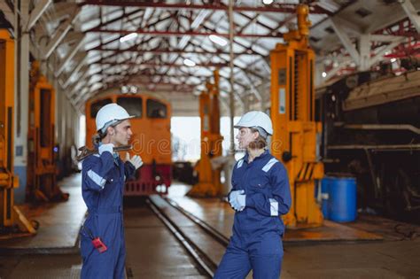 Train Engineer Team Working Together At Train Depot Service Maintenance Old Diesel Engine Train