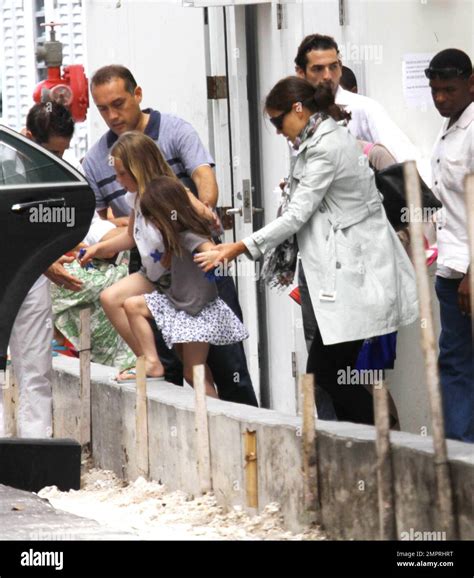 Katie Holmes Helps Daughter Suri And Her Friend Over A Wall As They