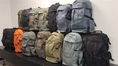 All Rucksacks Are Different Colors With The Rucksacks Shown On A Black Shelf Background Picture