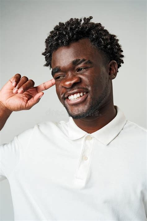 A Man Is Playfully Stretching His Face With His Finger Stock Image