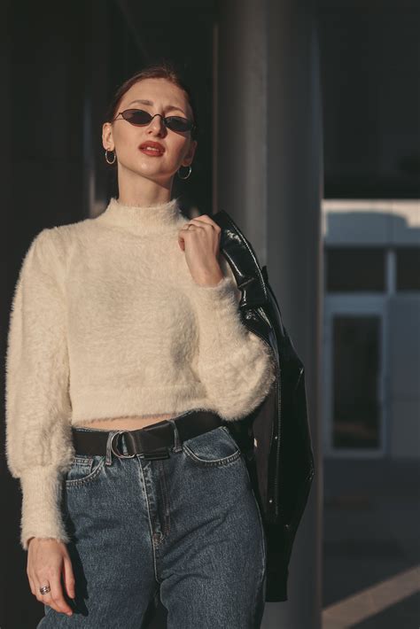 Woman In Gray Jacket Wearing Sunglasses Holding Handcuffs · Free Stock
