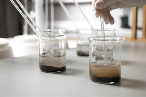 Beaker With Soil Extract On Light Table Laboratory Analysis Stock