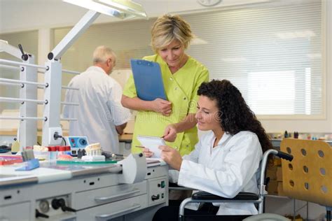 Manager Assisting Wheelchair Worker In Lab Stock Image Image Of Manager Analyzing 250315167