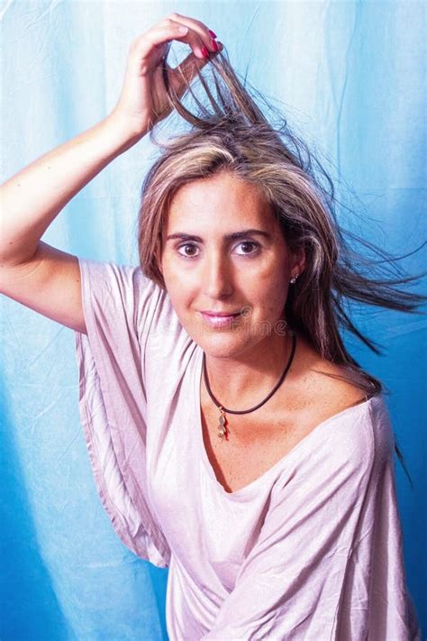 Mature Woman Shows Off Her Blonde Hair With Renewed Color After Receiving A Makeover Stock