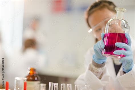 Girl Babe Examining Pink Liquid Conducting Scientific Experiment In Laboratory Classroom
