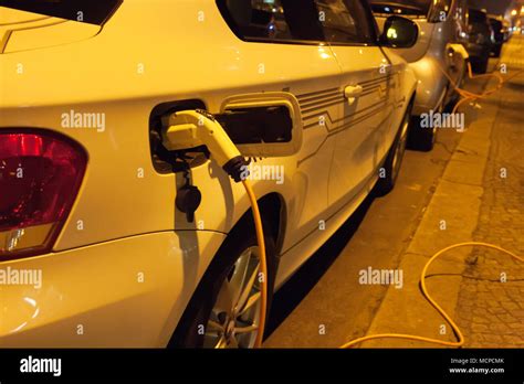 Electric Cars Charging At Night In City Street Charging White Electric Car Stock Photo Alamy