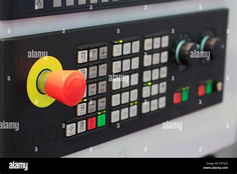 Cnc Machine Control Panel With Emergency Stop Button On Foreground