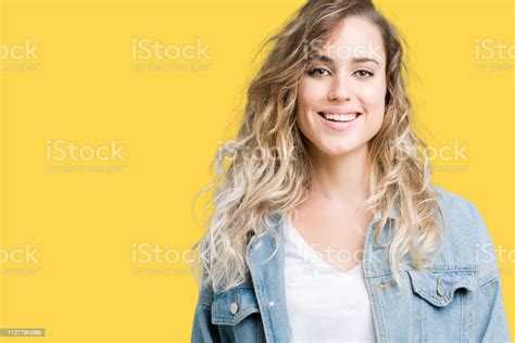 아름 다운 젊은 금발 여자 얼굴에 행복 하 고 시원한 미소와 고립 된 배경 위에 데님 재킷을 입고 운이 좋은 사람 곱슬 머리에 대한 스톡 사진 및 기타 이미지 Istock