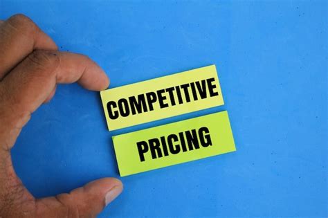 Premium Photo Hand Holding Colored Paper With The Word Competitive