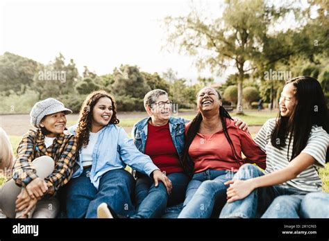 Happy Multi Generational Group Of Women With Different Ethnicities Having Fun Sitting On Grass