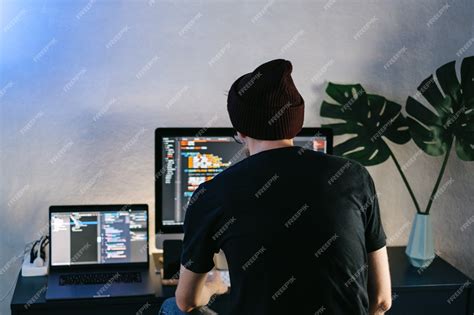 Premium Photo Young Man Mobile Developer Writes Program Code On A