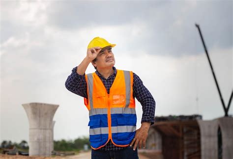 Premium Photo Foreman Worker In Hardhat At The Infrastructure Construction Site Asian