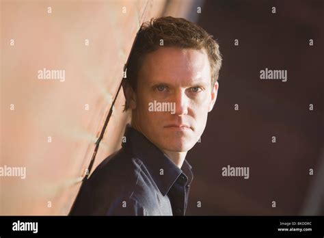 Man Leaning Against A Wall Stock Photo Alamy
