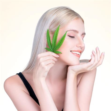 Premium Photo Closeup Personable Blond Hair Woman Holding Cbd Leaf In Isolated Background