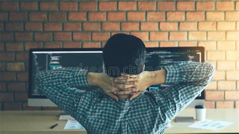 man programmers are stressed and hand holding nose with headache at the