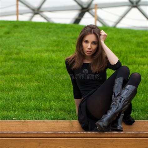 Young Beautiful Woman Sitting On A Bench In The Autumn Park Stock Image