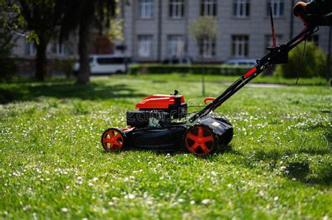 Communal Services Gardener Worker Man Using Lawn Mower For Grass