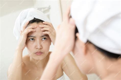 Premium Photo Problem Skin Concerned Young Asian Women Popping Pimple On Cheek While Standing