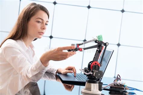 A Young Woman Writes An Algorithm For The Robot Arm Science Research Laboratory For Robotic Arm