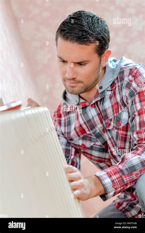 Man Fixing Heater Stock Photo Alamy