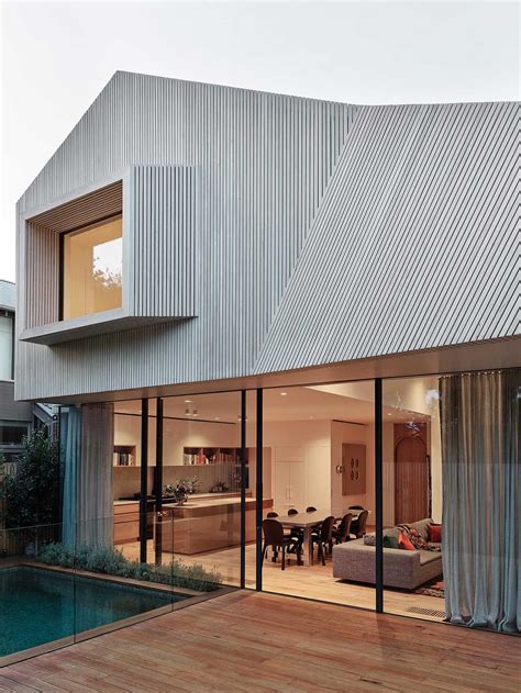 Angular Wood Slats And A Projecting Window Create A Unique Exterior