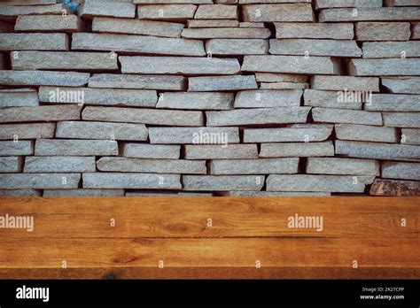 The Background Is Blank Wooden Boards And A Textured Brick Wall With