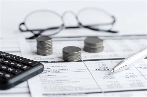 Premium Photo Coin A Calculator A Pen On The Business Papers