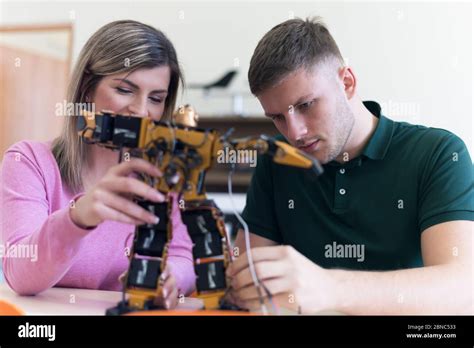 Scientists Engineers Designing Small Human Robot Setting Artificial Intelligence Humanoid Robot