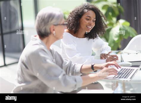 Software Development Team Discussing Algorithms On Computer Screen In