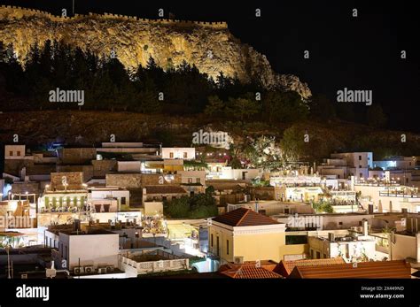 Lindos Village Night View Of A Town With Illuminated Buildings And A