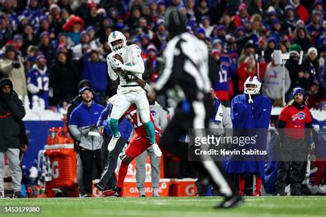 Jaylen Waddle Of The Miami Dolphins Catches A Pass Over TreÕdavious