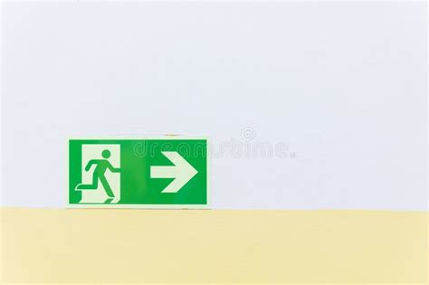 Emergency Exit Symbol On The Hospital Wall To Inform Escape Route From Fire Alarm In An