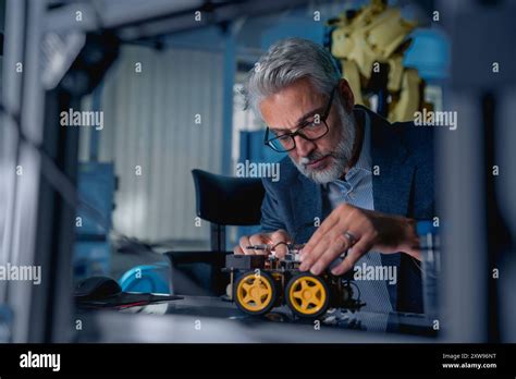 Automation Robotics Engineer Assembling Robotic Car Prototype For Delivery Warehouse Concept