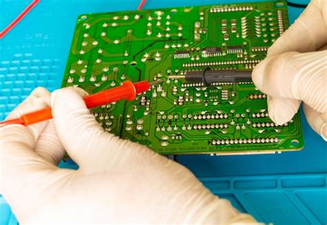 Premium Photo A Closeup Of A Circuit Board Being Checked By An Engineer Using A Test Head
