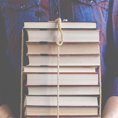 A Man Holds Many Books Tied With A Rope Stock Photo Image Of Adult Pile