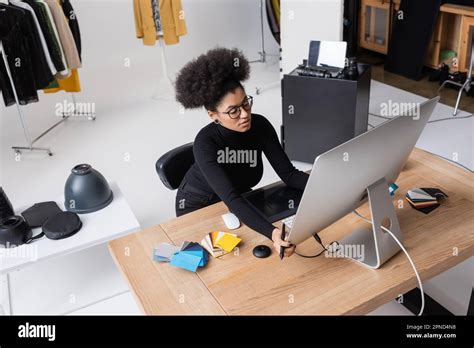 High Angle View Of African American Retoucher Adjusting Computer Monitor Near Graphic Tablet And