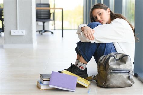 Premium Photo Upset Teen Girl Sit On Floor Sadly Look Out Window