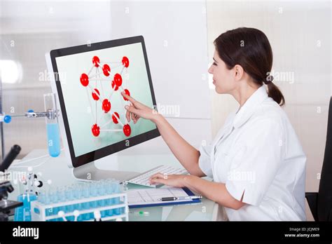 Female Scientist Touching Computer Screen In Lab Stock Photo Alamy