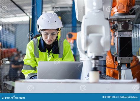 Female Technician Engineer Using Laptop Checking Automation Robotics At Industrial Modern