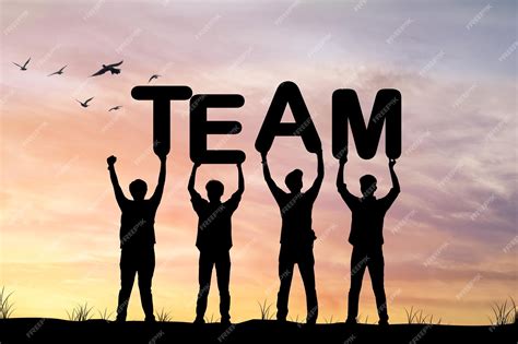 Premium Photo Silhouette Of Businessmen Holding Team Words In Sunset Concept As Teamwork And