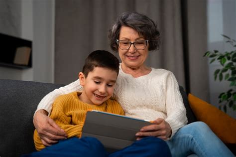Premium Photo Front View Grandson And Grandmother With Tablet
