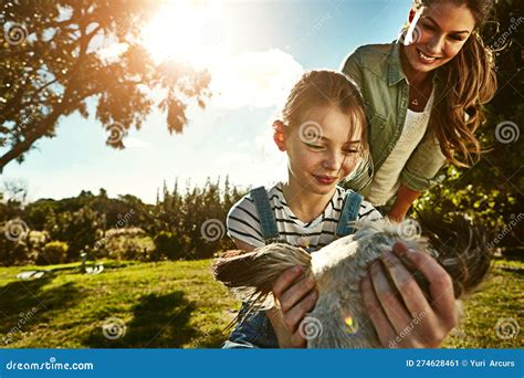 Showering Their Pup With Some Love A Mother And Daughter Spending Time
