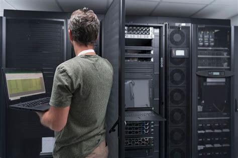 Premium Photo Data Center Engineer Using Laptop Computer Server Room