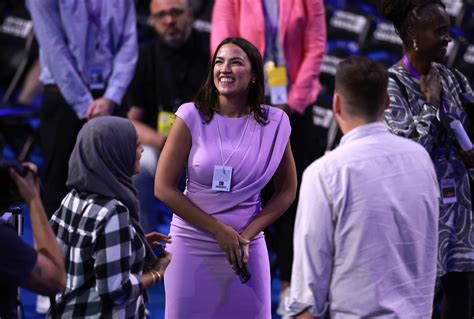 AOC Brings Pop Of Color To Chicago In Lilac Dress Ahead Of The DNC
