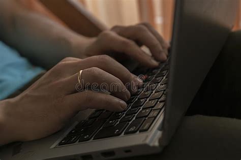 A Man Is Typing On A Laptop Keyboard Photographed From The Side Stock Photo Image Of