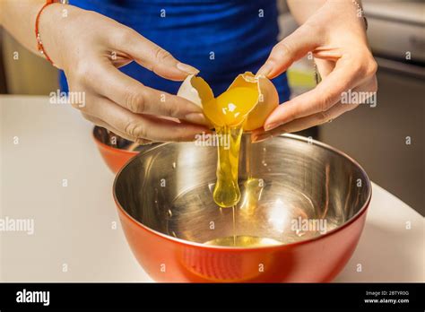 Woman S Hands Separating Egg Yolk From Whites Stock Photo Alamy