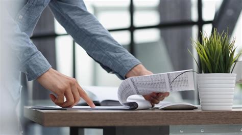 Premium Photo Businessman Reviewing Document Reports At Office Workplace