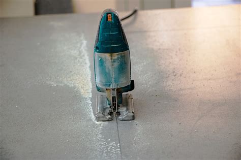 패널에서 전기 손 퍼즐과 건설 노동자 톱질 및 절단 부품의 남성 손 전기 퍼즐로 실내 장식을위한 건물 보드를 절단하는 과정 0명에 대한 스톡 사진 및 기타 이미지 Istock